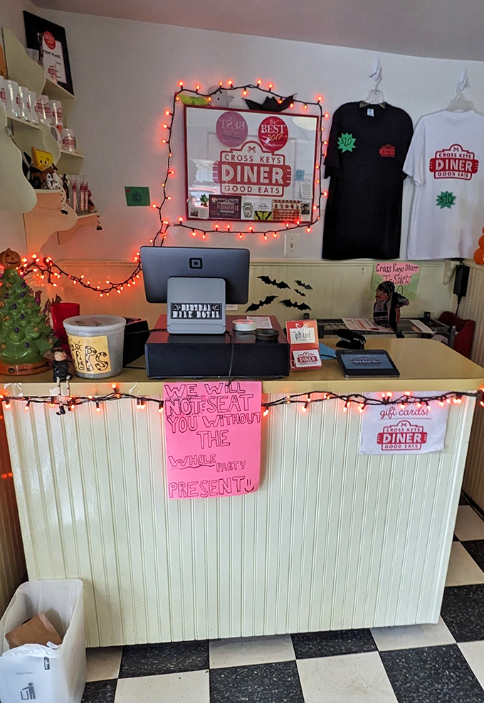 A host station decorated with twinkling lights and personality. That handwritten sign suggests they value full parties as much as full plates.