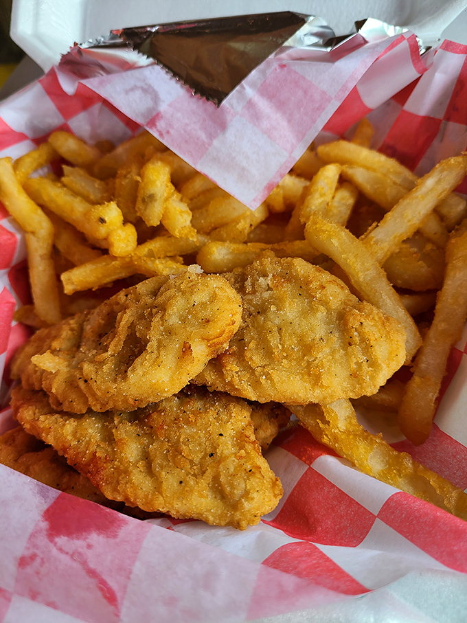 Golden-fried chicken tenders that crunch louder than your dad's knees. Paired with those fries, it's comfort food that gives an actual hug to your taste buds.