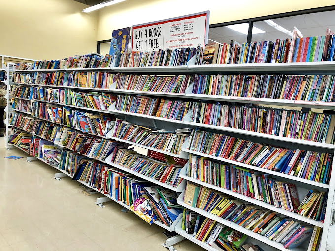 Books line shelves like literary soldiers, offering "buy 4 get 1 free" deals on knowledge.