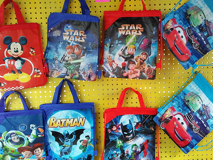 Childhood nostalgia hanging by strings &ndash; Batman, Mickey, and Star Wars bags ready to carry tomorrow's treasures for today's kids.