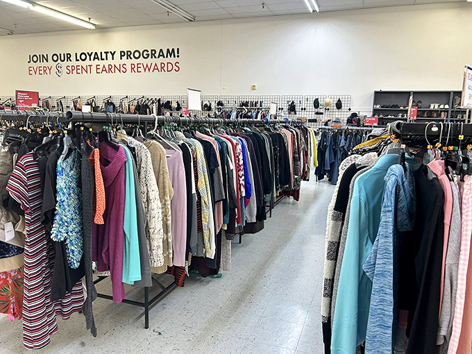 The clothing department's loyalty program sign hovers above a rainbow of garments. Fashion recycling at its most wallet-friendly.