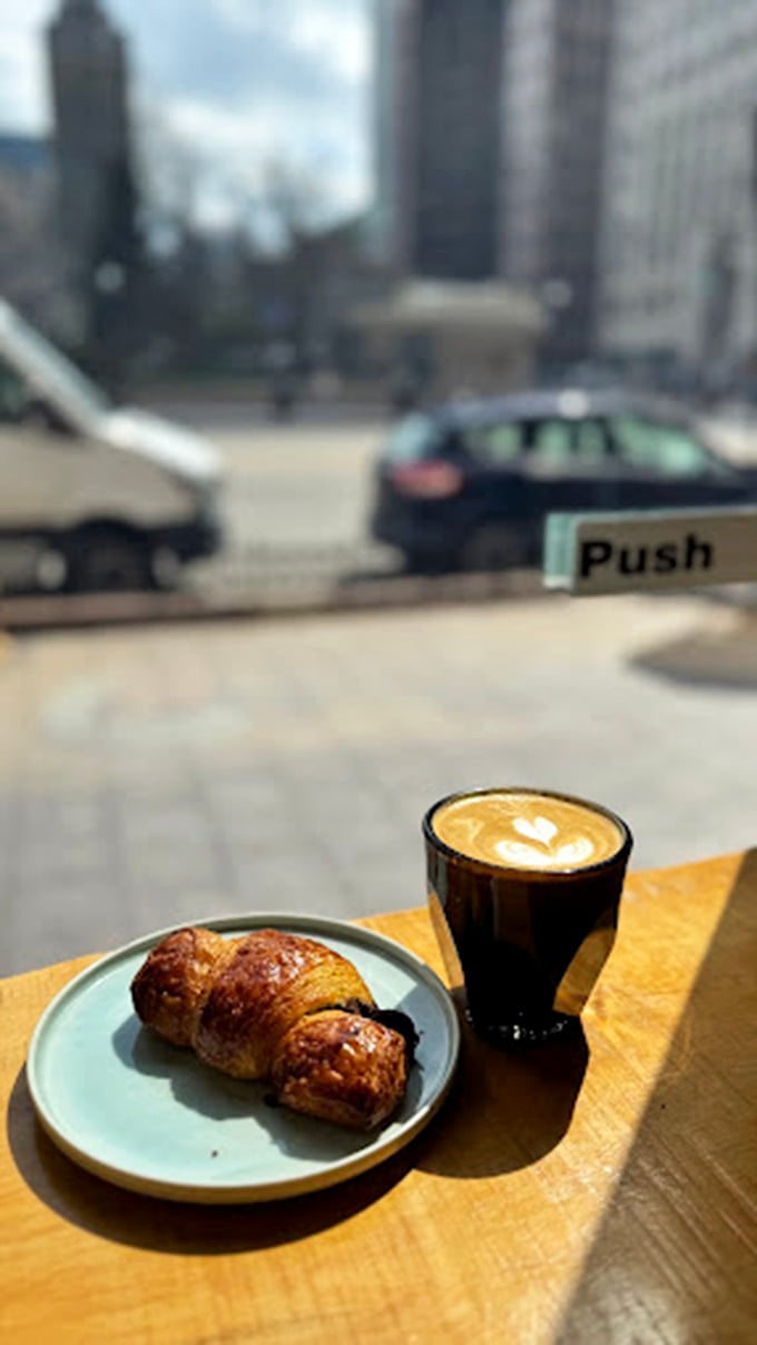 Urban poetry: a perfect latte, a buttery pastry, and Columbus architecture in the background. Some moments are worth savoring slowly.