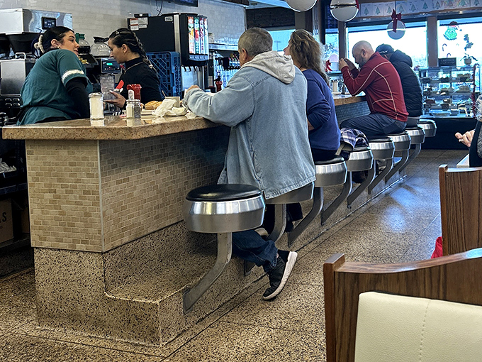 Counter seating: where solo diners become part of the breakfast ballet and servers remember how you take your coffee by visit two.