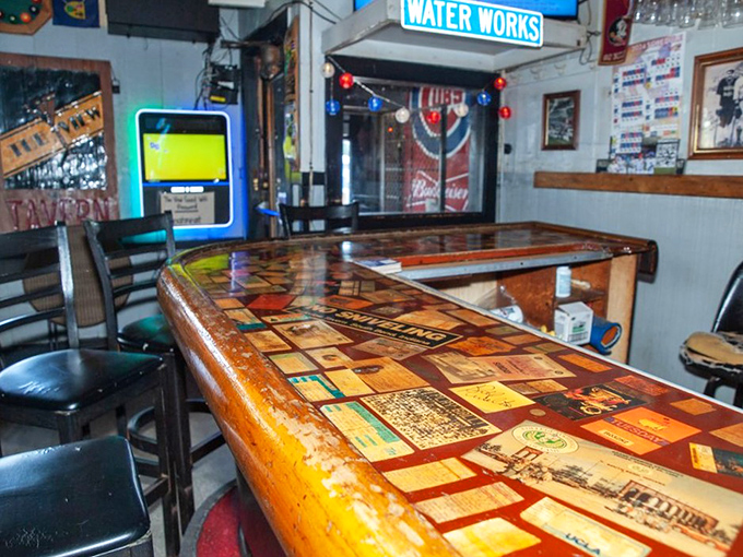 This bar top tells stories – decades of good times preserved under glass like a museum of merriment where your elbows are welcome.