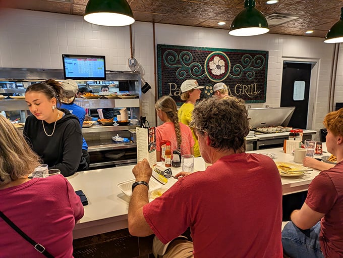 Where Southern hospitality meets efficiency—the counter seating offers front-row views of the kitchen ballet. Dinner and a show, Lowcountry style.