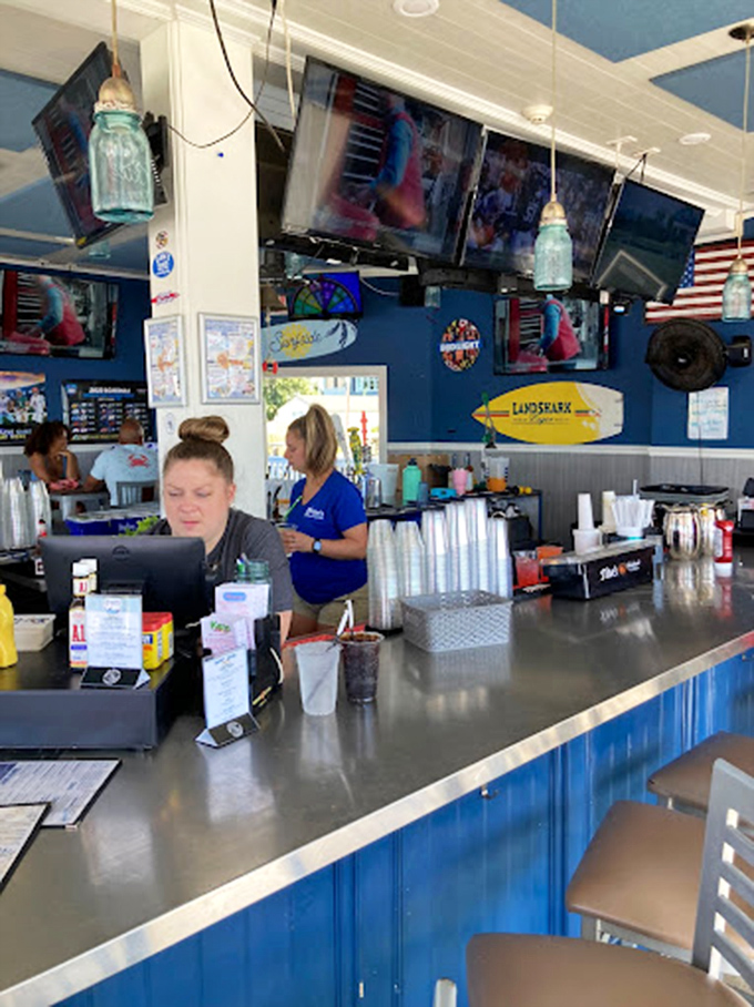 Behind this vibrant blue bar, cocktail magic happens. The nautical touches aren't just decor&mdash;they're reminders that great seafood awaits just beyond those shakers.