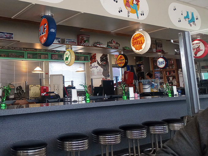 Vintage gas station signs watching over diners like colorful guardians of appetite. The Gulf and Shell logos have seen generations come and go.