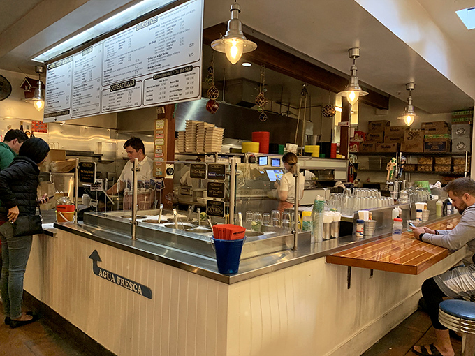 The open kitchen setup lets you witness the culinary choreography that transforms simple ingredients into extraordinary meals.