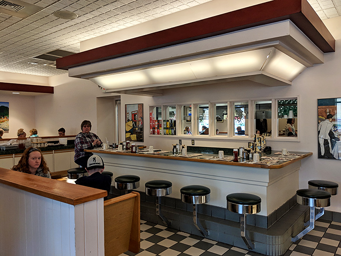 Counter seating that feels like a front-row ticket to the breakfast show. The black and white checkered floor adds that classic diner authenticity.