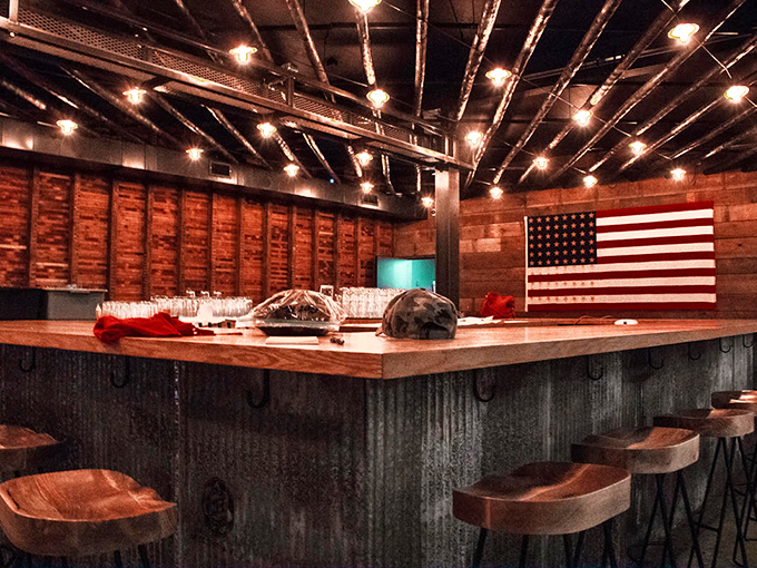 The bar isn't just serving drinks&mdash;it's serving possibilities. American flag backdrop says "patriotism tastes like good bourbon."