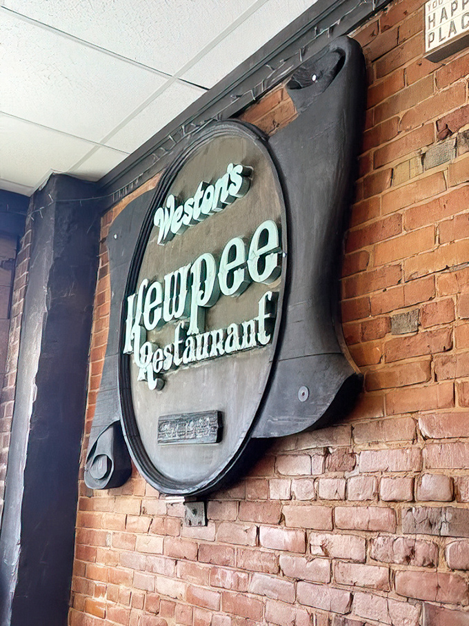 That iconic Kewpee sign against exposed brick &ndash; a beacon of burger hope in downtown Lansing since 1923.