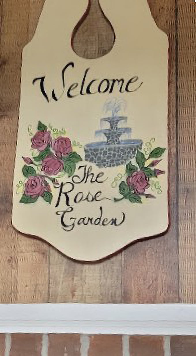 The handcrafted welcome sign with painted roses and fountain tells you everything you need to know&mdash;this place values tradition, beauty, and making you feel at home.