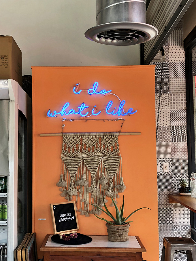"I do what I like" glows in neon against coral orange—a philosophy that translates directly to the confident, unfussy brilliance on your plate.
