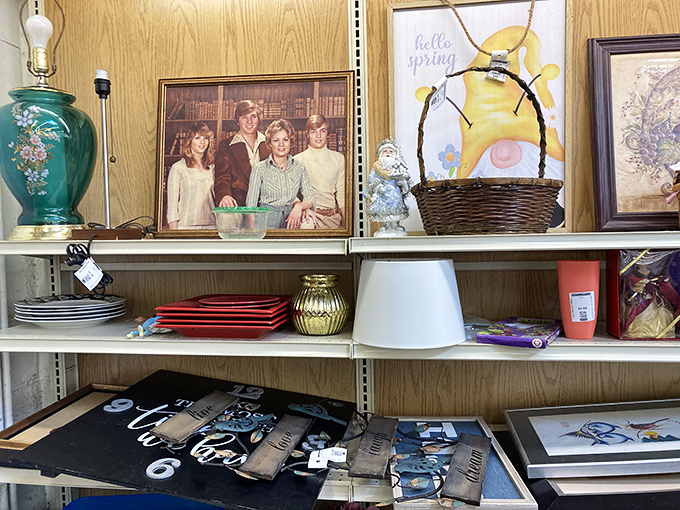 The home decor section: where someone's forgotten family portrait sits alongside seasonal decorations and vintage lamps in beautiful retail randomness.