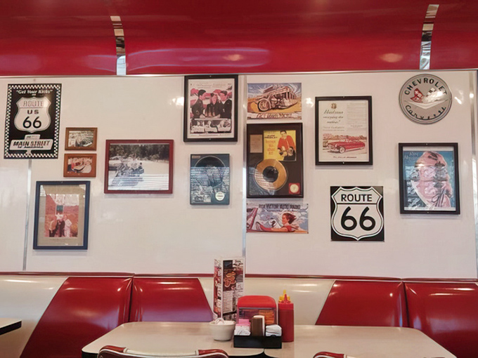 Route 66 memorabilia adorns the walls, turning your meal into a road trip through American dining history without leaving your booth.