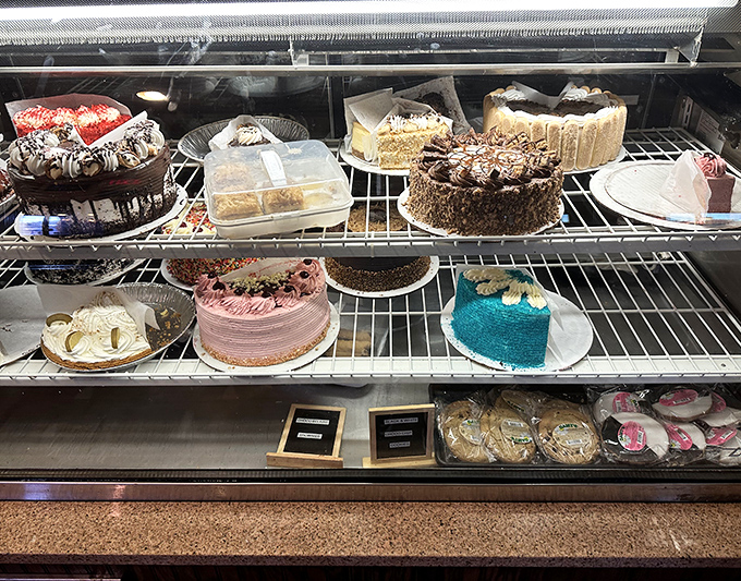 A dessert case that requires willpower of superhero proportions to resist. Each cake is basically therapy without the hourly rate.