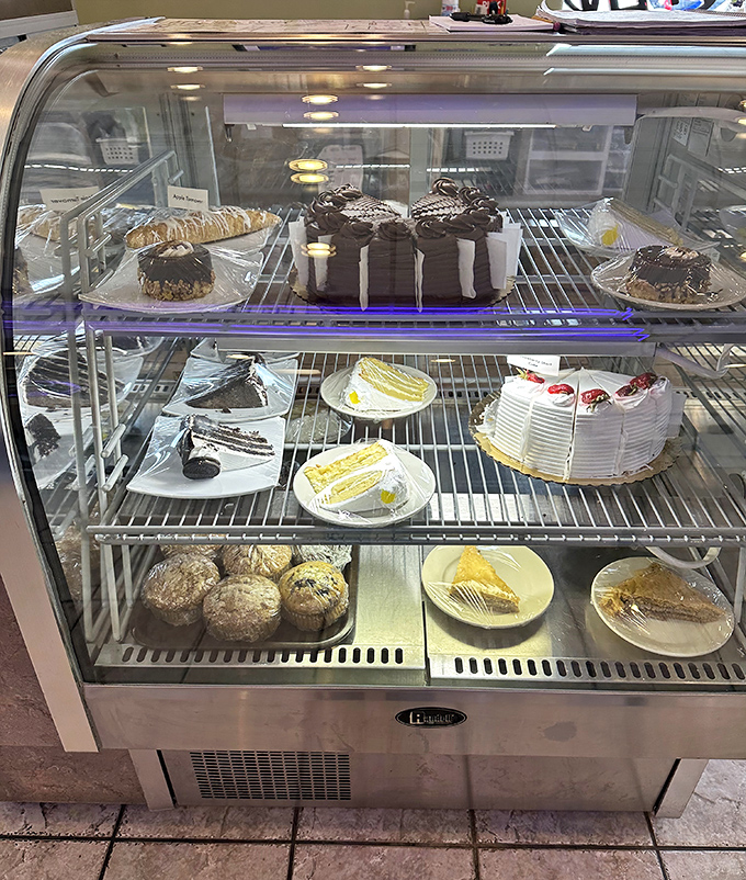 The dessert case—where willpower goes to die. Each slice of cake is a siren song of sweetness calling your name.