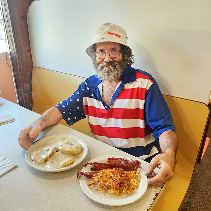 A patron enjoying what appears to be the full Hyde's experience&mdash;biscuits and gravy, eggs, bacon, and the satisfaction of knowing some things never change.