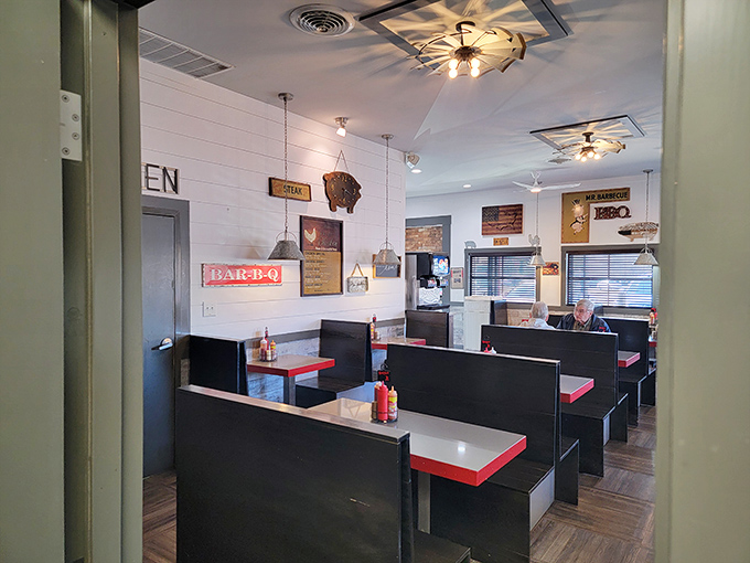 Black booths, white walls, and red accents—a color scheme that says "We're focused on the food, not winning design awards."