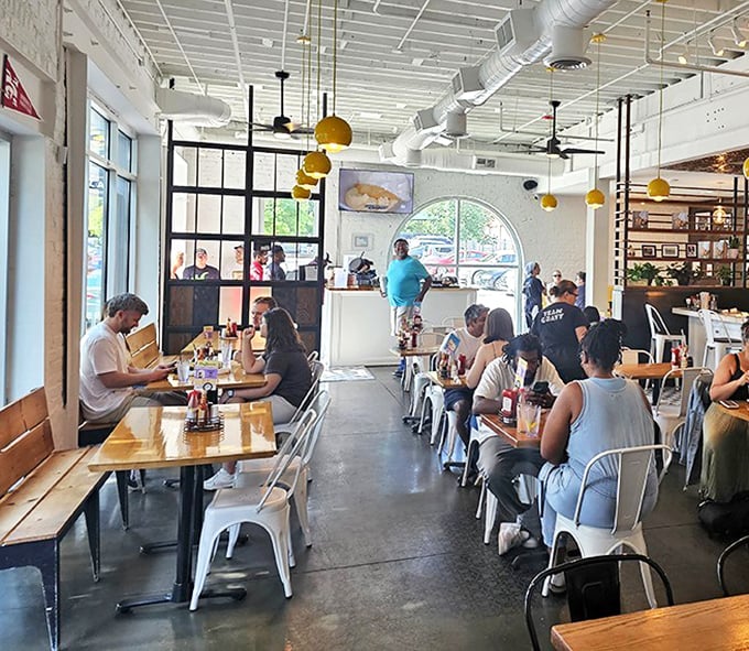 A full house of happy diners under those signature yellow lights&mdash;each face telling the same story: "Worth. Every. Calorie."