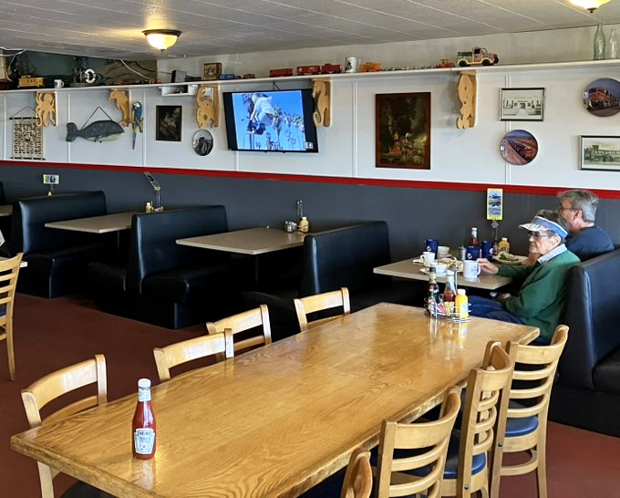 Blue booths line the walls where satisfied customers dive into bowls of Oregon's coastal bounty, creating memories with every spoonful.