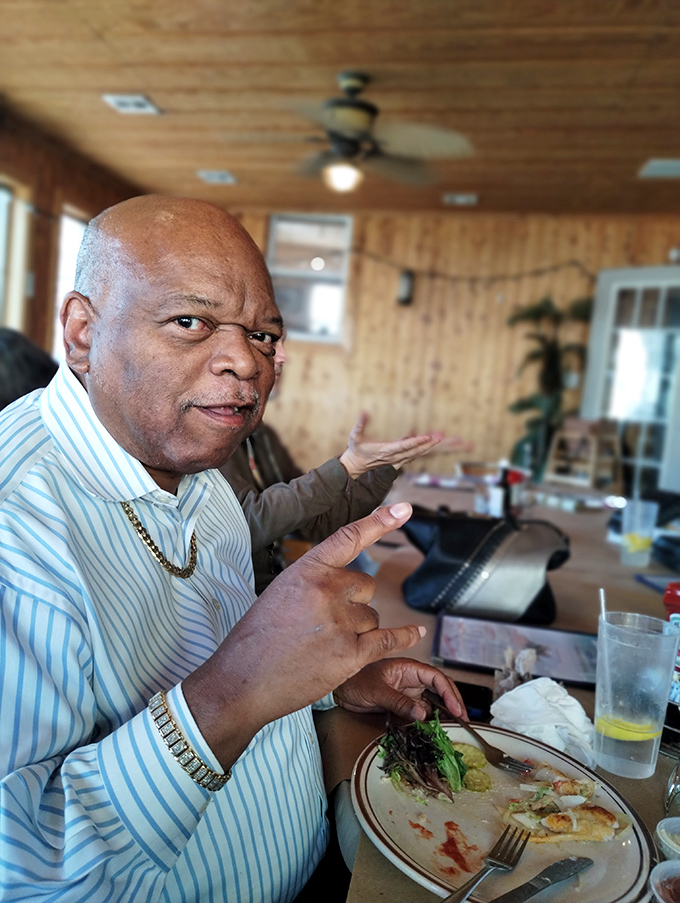 Happy diners proving that paper plates and genuine satisfaction go hand in hand.
