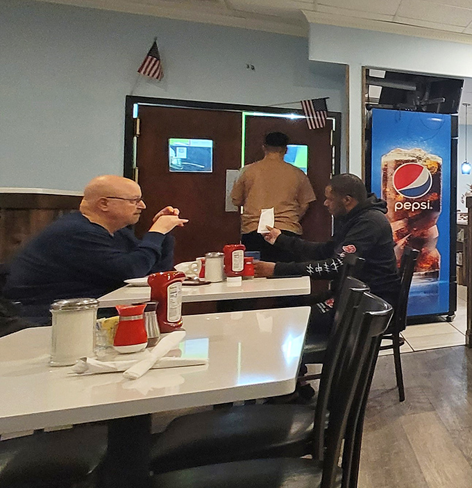 The true measure of any diner: locals deep in conversation, solving world problems over bottomless coffee cups.