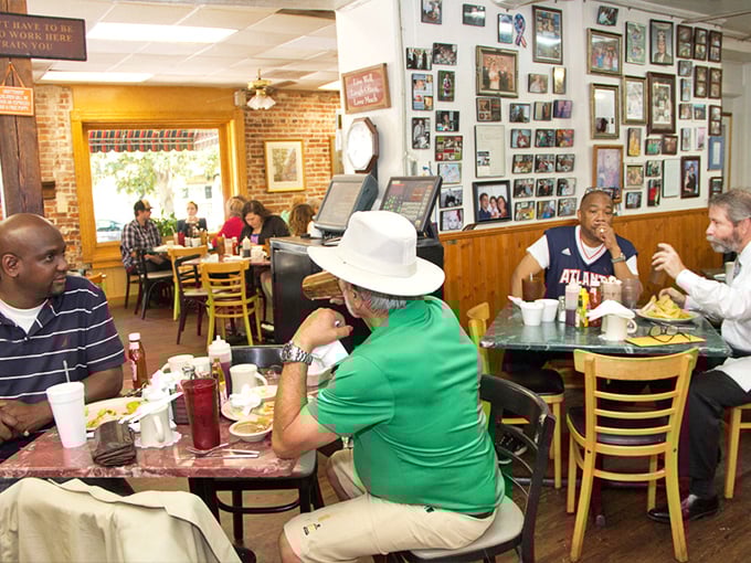 Regular customers sharing morning conversations over steaming plates create the authentic diner atmosphere money can't buy.