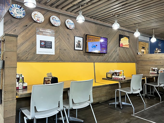 The dining area's wood-paneled charm and bright yellow booths create the perfect setting for the serious business of meat appreciation.