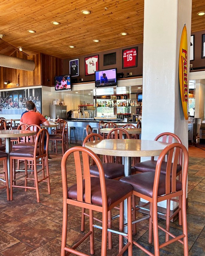 High-top tables and sports memorabilia create that perfect "neighborhood joint" atmosphere. The kind of place where good times and good food naturally converge.