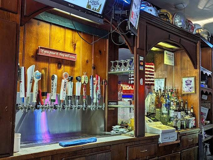 A bar setup that says, "We're not trying to reinvent drinking, we're just trying to do it right"&mdash;complete with the welcoming sign that beer is meant to bring joy.