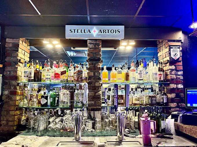 A backlit bottle display that says, "Yes, we take our drinking as seriously as our eating." Liquid art gallery for grown-ups.