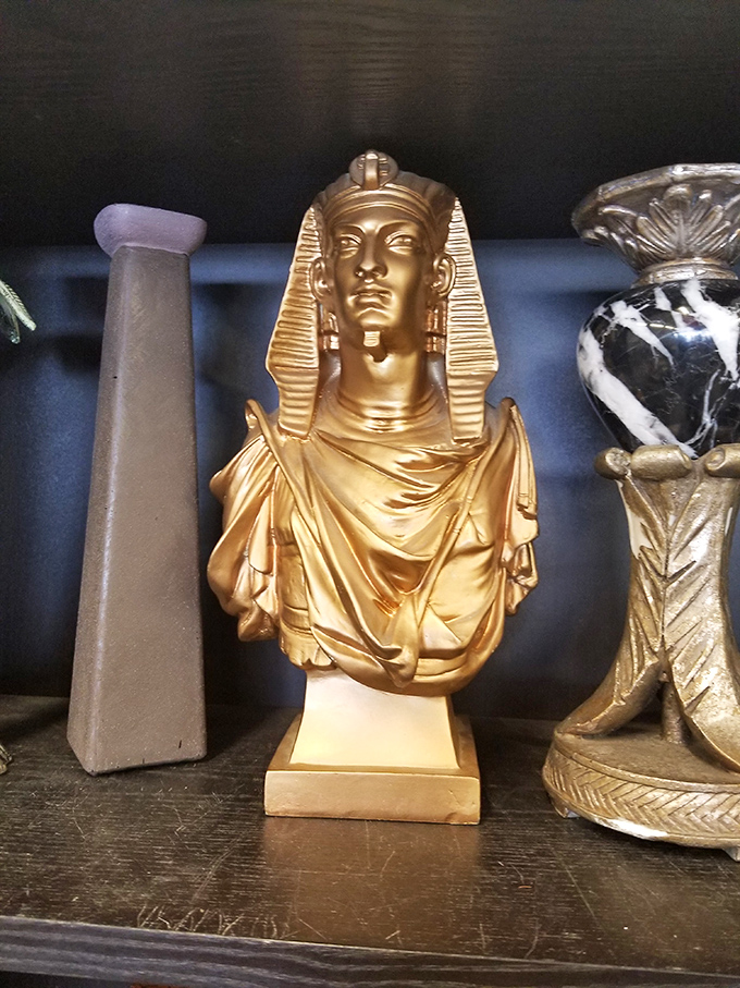 A golden pharaoh bust that brings ancient Egyptian glamour to your bookshelf without requiring an archaeological expedition.