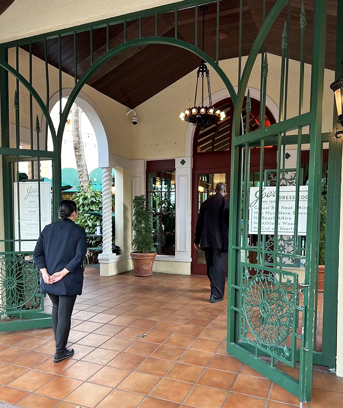 Suited staff stand ready at the entrance, guardians of a dining tradition where every meal feels like a special occasion.