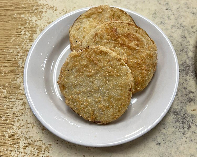 Golden discs of fried green tomatoes&mdash;Southern currency in food form. Crispy, tangy perfection that makes you understand why they wrote a movie about them.