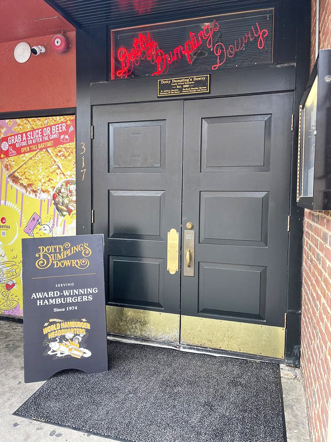 The neon sign glows like a beacon for burger pilgrims. That door has welcomed countless hungry souls seeking comfort food nirvana. 