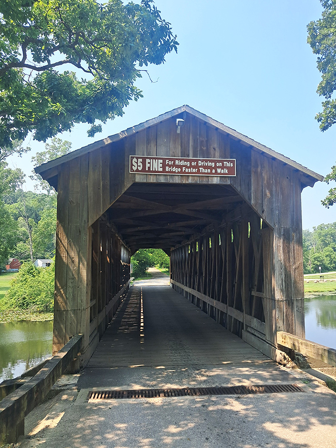 That famous $5 fine warning greets every visitor. The bridge's entrance serves as a portal between centuries, asking only that you slow down to appreciate it.
