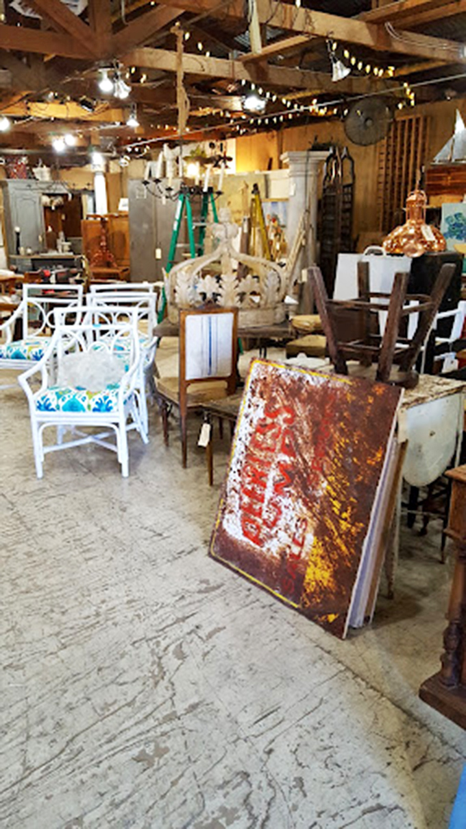 String lights cast a warm glow over this furniture tableau, where mismatched chairs somehow create a perfectly harmonious seating arrangement.