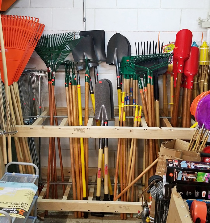 The garden tool wall—where weekend warriors and serious green thumbs alike find the perfect implements for battling unruly backyards.
