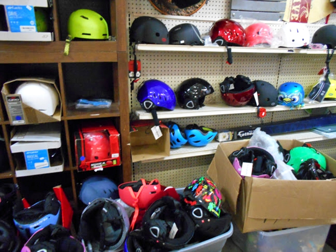 A rainbow of safety helmets stands ready for new adventures—proof that Dave's treasures span from nostalgic to practical.