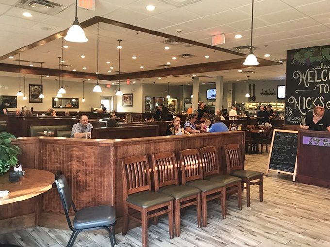 The booths at Nick's: where strangers become regulars and regulars become family, all under the warm glow of pendant lights.