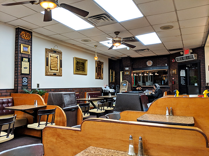 Simple wooden booths, framed calligraphy, and ceiling fans create that perfect "focus on the food" atmosphere that serious eaters crave.