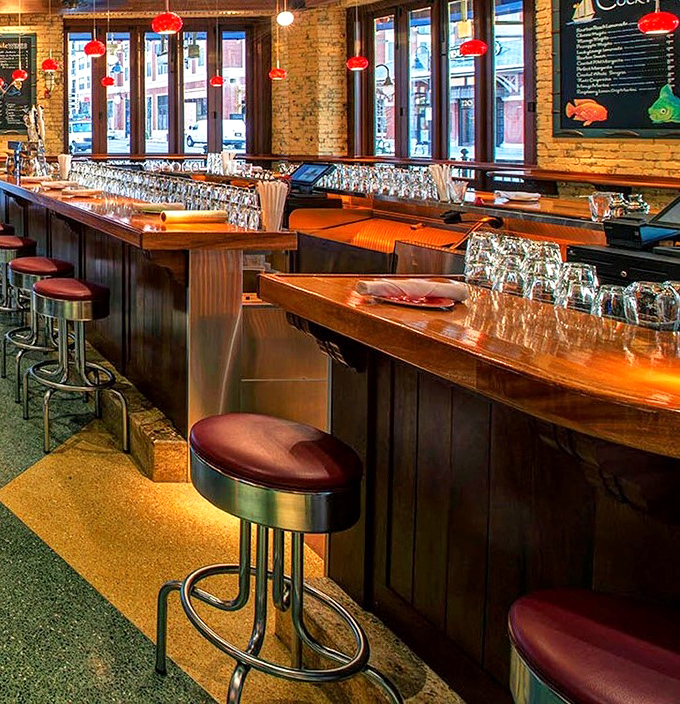 Red pendant lights cast a warm glow over the polished bar &ndash; the kind of place where everybody doesn't know your name, but soon will.