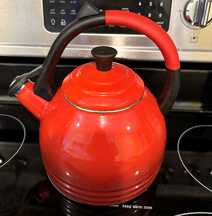 That cherry-red kettle practically whistles with personality. Kitchen treasures like this make thrifting the culinary explorer's secret weapon.