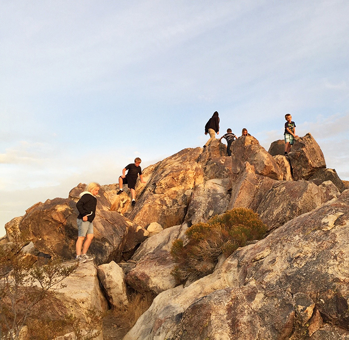 Hikers scaling nature's staircase at golden hour&mdash;where the workout meets the reward in a perfect desert equation.
