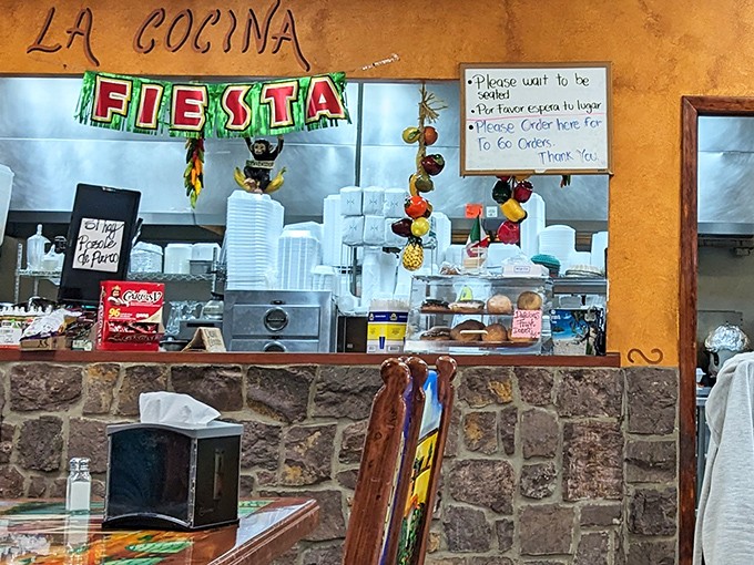 "La Cocina" &ndash; where the magic happens. Peek through to the kitchen where generations of recipes come to life in a flurry of activity and aromatic spices.