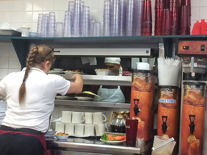 Behind the scenes, where breakfast magic happens amid stainless steel efficiency and the rhythmic dance of experienced hands.