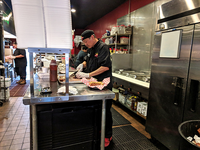 Where the magic happens&mdash;skilled hands transforming simple ingredients into smoky masterpieces. This kitchen knows that patience is the secret ingredient in great BBQ.