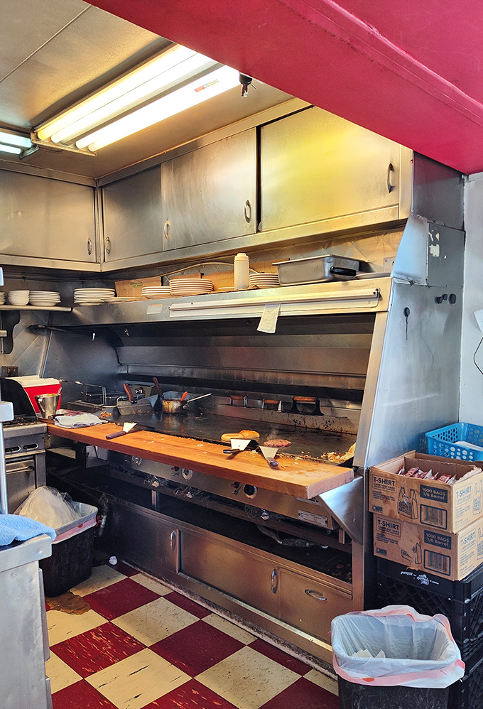 The kitchen pass&mdash;where breakfast dreams are born on a well-seasoned griddle that's seen more action than most Broadway stages.