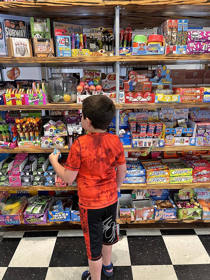 A young explorer contemplates life's most important decision: which candy provides the optimal sugar-to-parental-approval ratio.